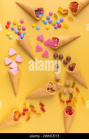 Colourful sweets, gummy bears, chocolate lentils falling out of ice ...