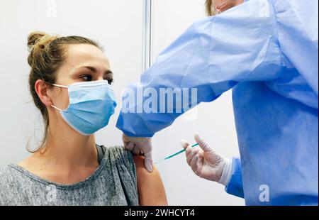 A woman receives a Pfizer-BioNTech coronavirus vaccine at a COVID-19 ...