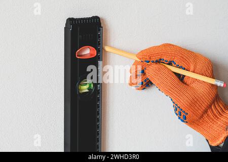 Worker's hands with bubble level. measuring with bubble level ...