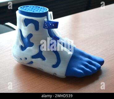 Model of leg printed on a 3D printer from black rubber, close-up. Part ...