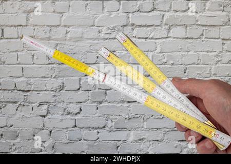 Male hand holding folding rule with millimeter and centimeter ...