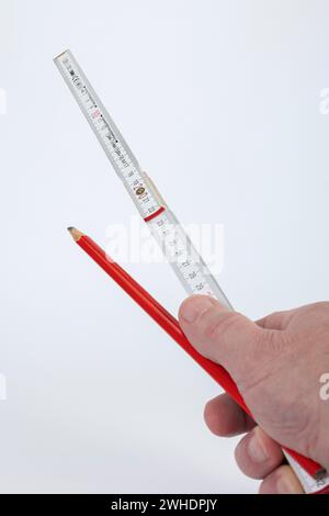 Man's hand holding folding rule with millimeter and centimeter ...