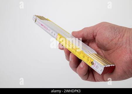 Male hand holding folding rule with millimeter and centimeter ...