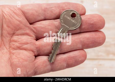 Broken apartment key on man's palm, dimple key, cylinder key, white ...