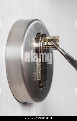 Broken key, pull out key bit with tweezers, detail, symbol image ...