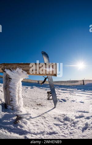 Snowboard leaning on a wood rail Stock Photo - Alamy