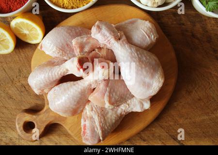 Raw uncooked chicken legs, drumsticks on blue wood background, meat ...