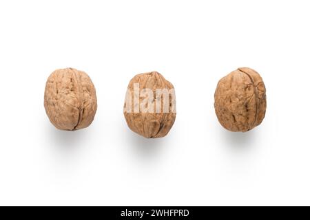 Three walnuts top view on white background, from above Stock Photo - Alamy