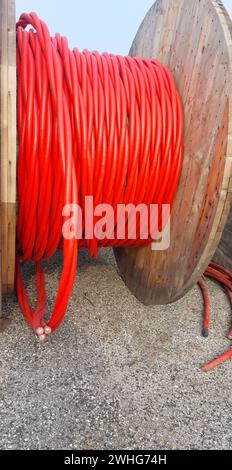 huge high voltage cable reels in power line construction site. road ...