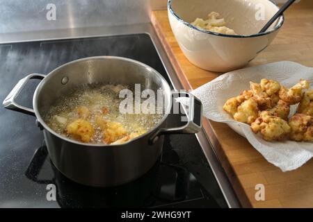 Raw slices of cauliflower in frying pan. Cooking cauliflower steak ...