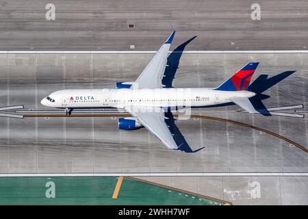 Delta Airlines Boeing 757 at LAX airport connected to jet bridge aerial ...