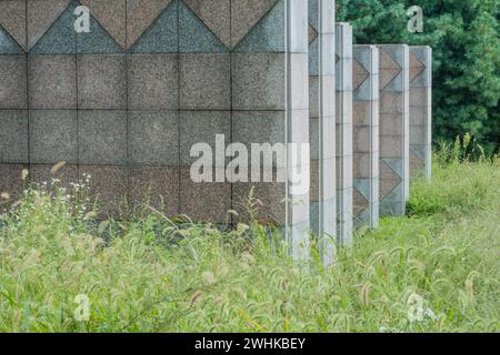 Series of concrete walls with marble triangular patterns in public park ...