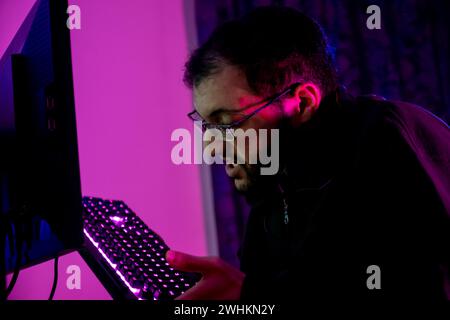 Gamer guy feeling angry and trying to smash his keyboard and mouse ...