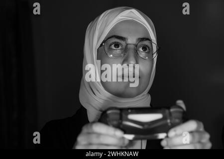 arabic muslim girl playing console games Stock Photo - Alamy