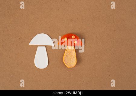 a peeled tangerine craft in shape of mushroom sitting on top of a table ...