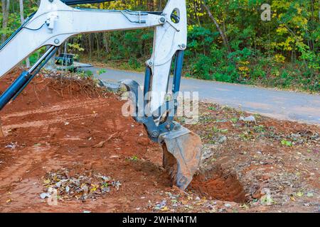 Excavator dig trenches for laying piping that will carry rainwater to ...