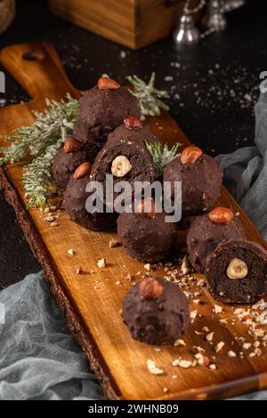Dark chocolate truffles with hazelnuts and chopped hazelnuts over ...