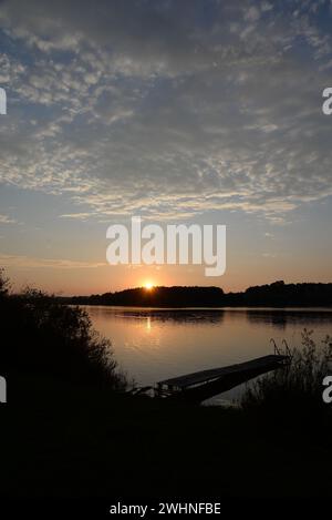 Neumarkt am Wallersee: lake Wallersee at sunset, couple on bench, Alps ...