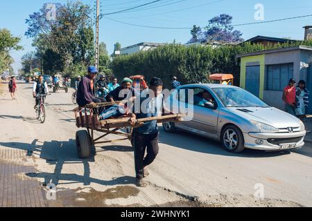 Traditional rickshaw on the Antsirabe city streets. Rickshaws are a ...