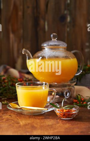 Glass cup with sea buckthorn tea with spices Stock Photo - Alamy