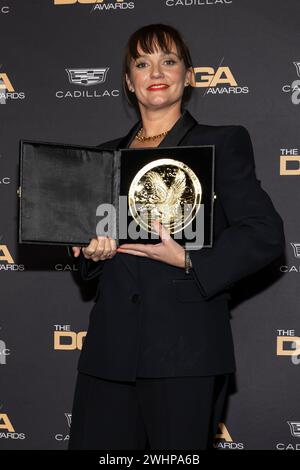 Kim Gehrig poses in the press room with the award for outstanding ...