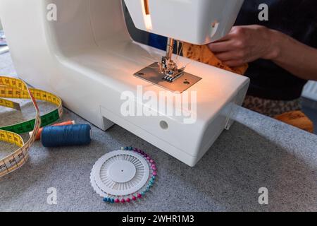 Reels with white threads for a sewing machine on a polished wooden ...