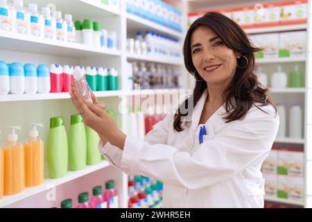 Middle age hispanic woman pharmacist smiling confident standing with ...
