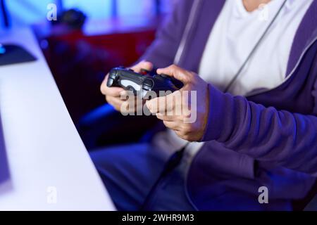 Young hispanic man streamer playing video game using smartphone at ...