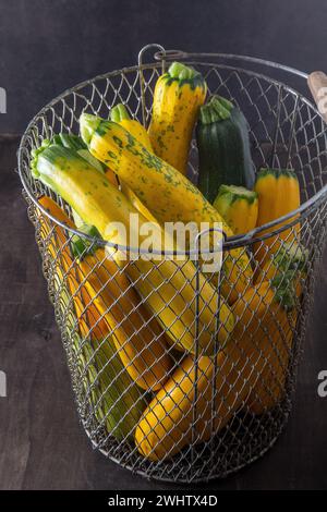 Yellow green leopard spotted zucchini. Vegetables on the table ...