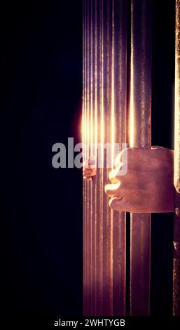 Detention, imprisonment. Prison cell and hands holding the bars. 3d ...