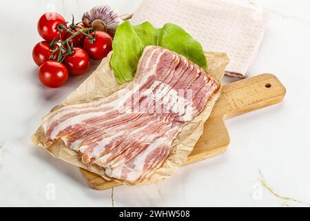 Sliced raw pork bacon oved board Stock Photo - Alamy