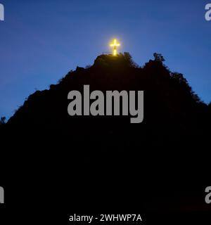 Illuminated cross on the Pinnerkreuz viewing peak in the evening ...