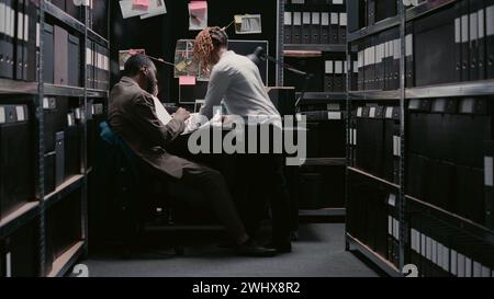 African american agents examining physical evidence to uncover new ...