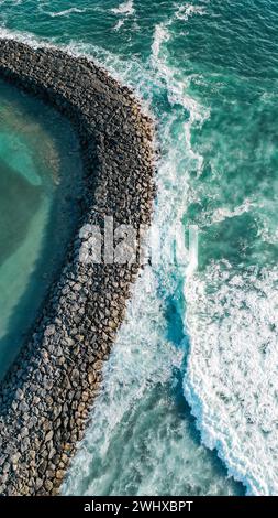 Aerial view of a seawall with clear turquoise water Stock Photo - Alamy