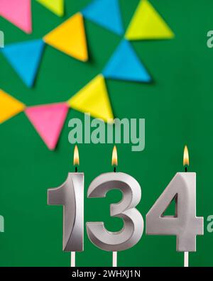 Birthday card with candle number 134 - Green background Stock Photo - Alamy