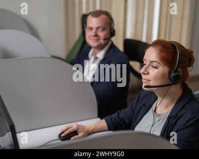 Two friendly call center employees talking to customers. Man and woman ...