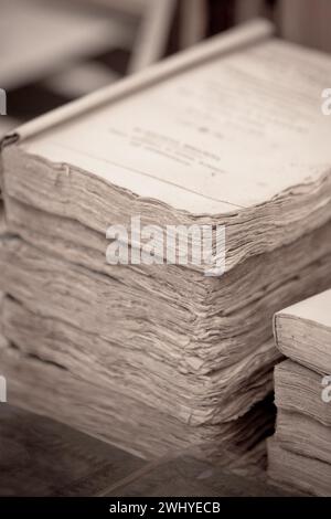 Stack of old ancient shabby books on a white wooden background ...