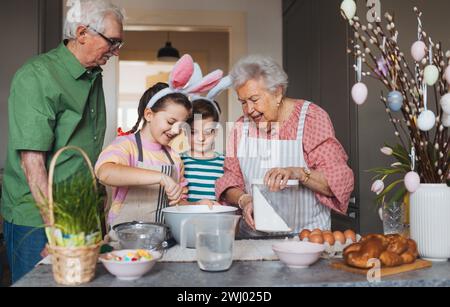 Grandparents with grandchildren preparing traditional easter meals ...