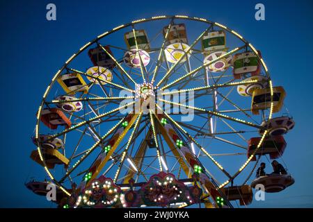 Inside an amusement park the colors of the Ferris wheel Stock Photo - Alamy
