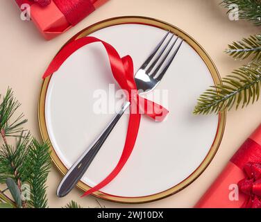 Wrapped present with a white bow and round paper gift tag on a white ...