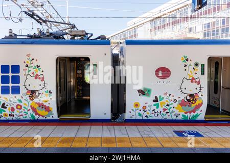 Hello Kitty, in a Japan Rail train conductor uniform, aboard the ...