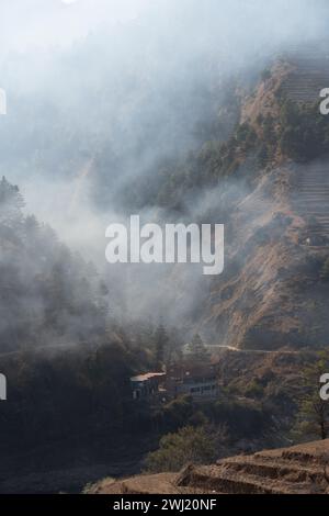 A wildfire burning a steep hillside in Nepal in the dry season with ...