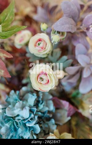 Faux flower arrangement with hydrangeas and roses in muted colors Stock ...