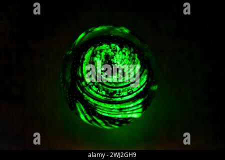 A transparent glass ball with inclusions casts real shadows on a white ...