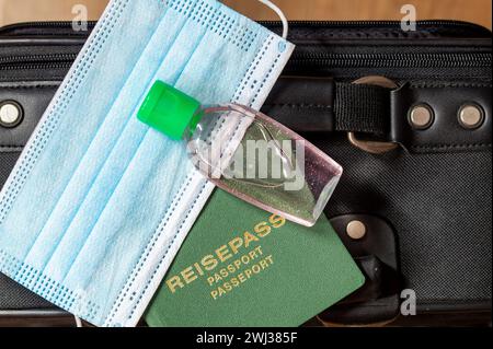 luggage with surgical mask, sanitizer bottle and woman sunglasses ...