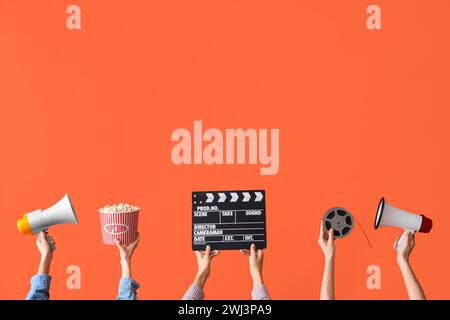 Many hands with bucket of popcorn, movie clapper and megaphone on ...