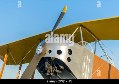 Cockpit with an engine with a propeller and wings of a yellow vintage ...