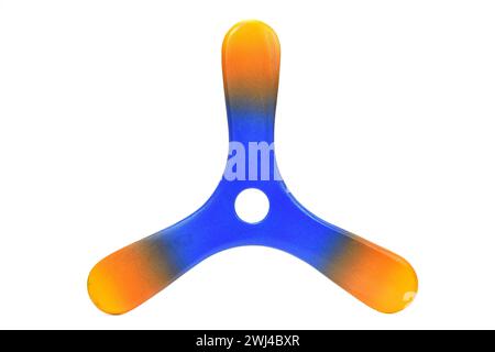 Wooden boomerang painted orange, and yellow with color splashes ...