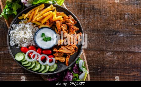 Chicken served with rice, vegetable salad, and a bowl of soup Stock ...