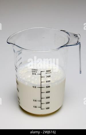 a container with graduated milk for measurement Stock Photo - Alamy